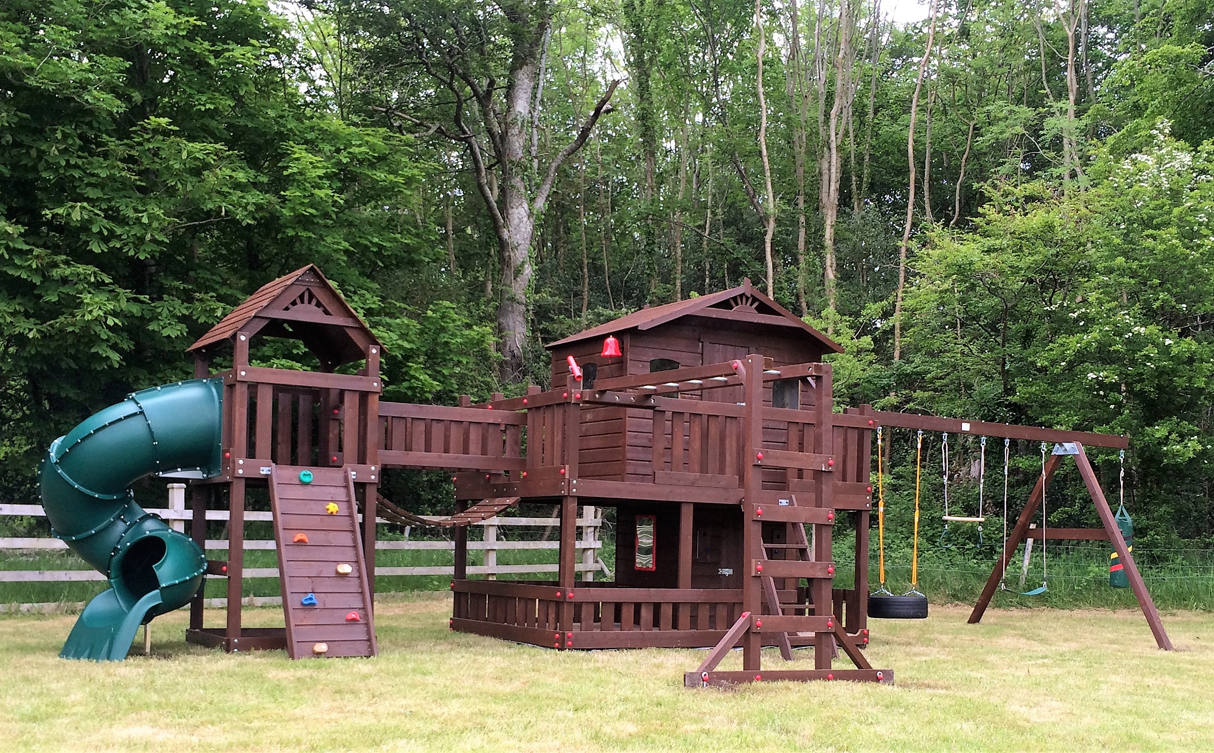 Large tree house,spiral tube slide,monkey bar beam,swing set,